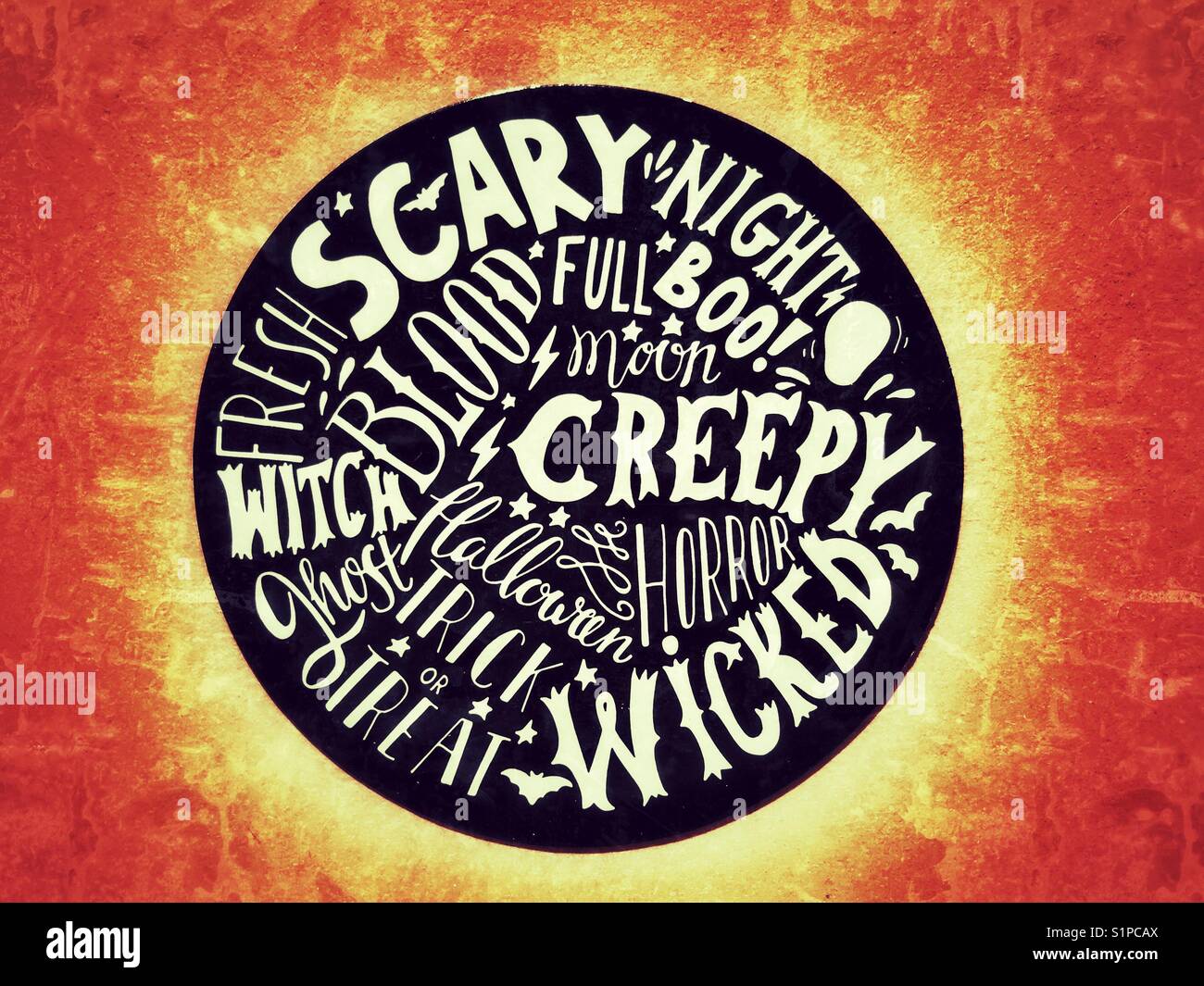 Hallowe'en. Spooky word disc on orange Stock Photo - Alamy