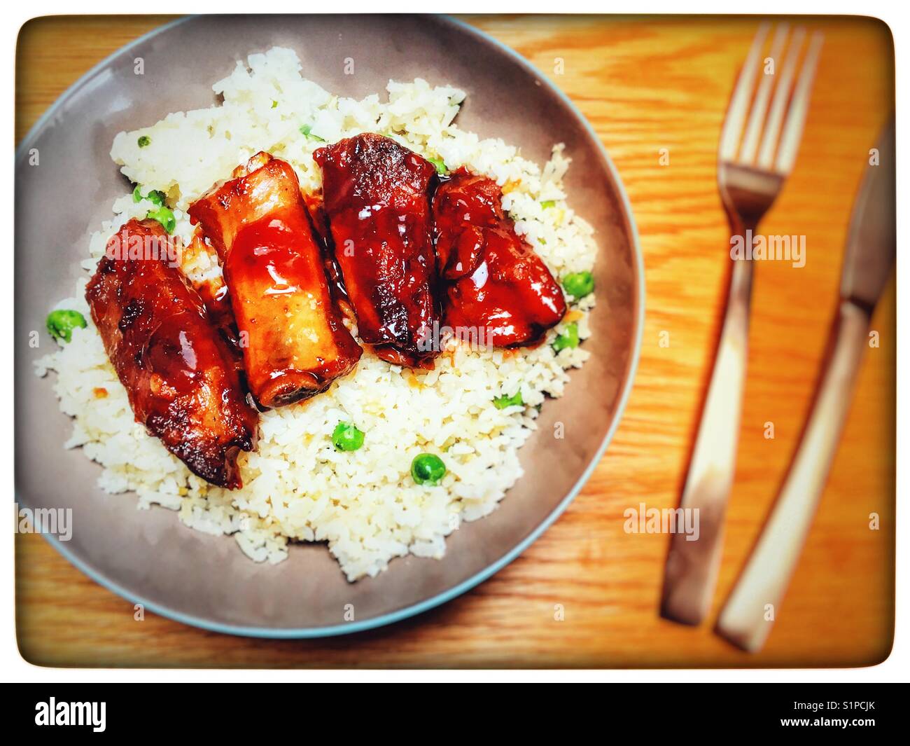 Sticky ribs with rice Stock Photo - Alamy