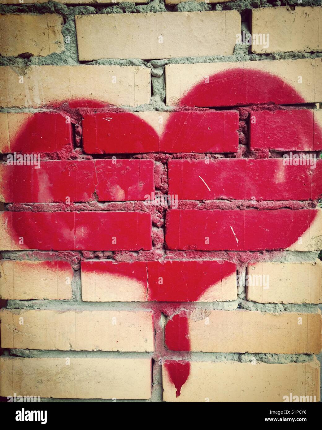 Heart symbol on brick wall hi-res stock photography and images - Alamy