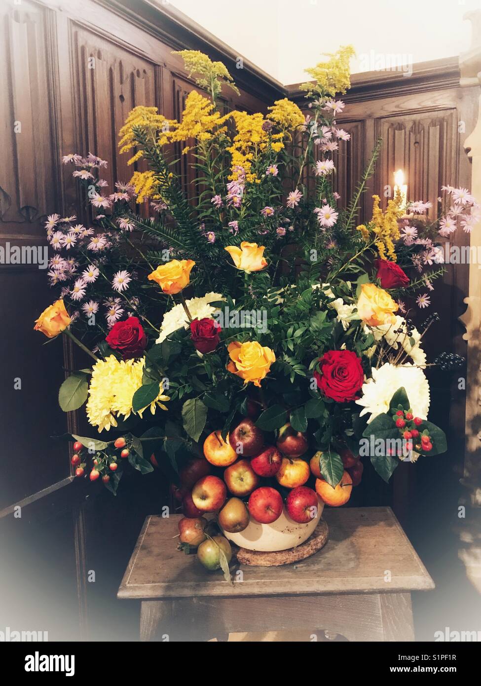 Arrangement of fresh fruit and flowers in a church harvest festival ...