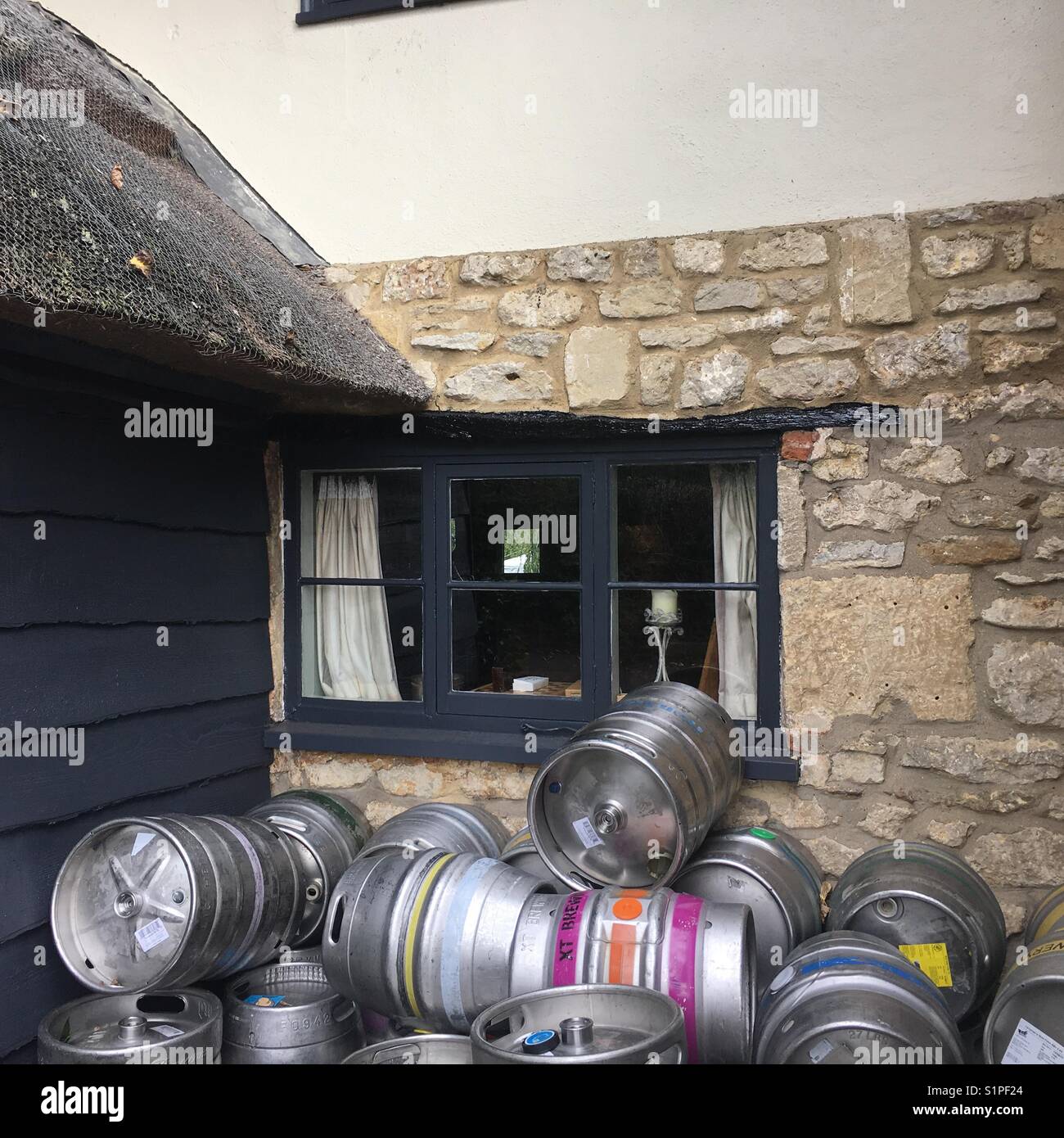 Kegs of beer outside Oxford pub window Stock Photo - Alamy