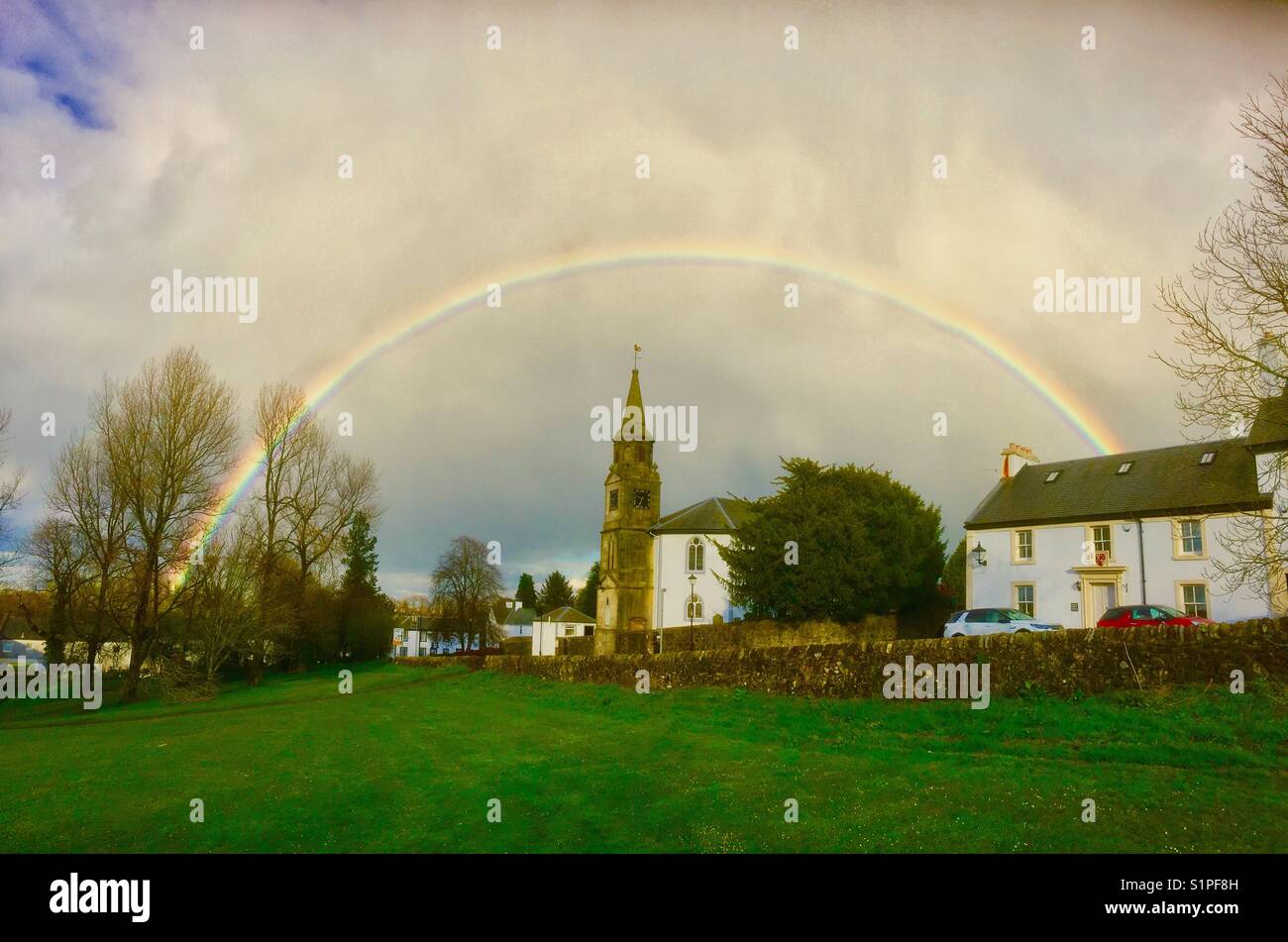 Rainbow over Eaglesham Parish Church, Scotland, on a stormy afternoon ...