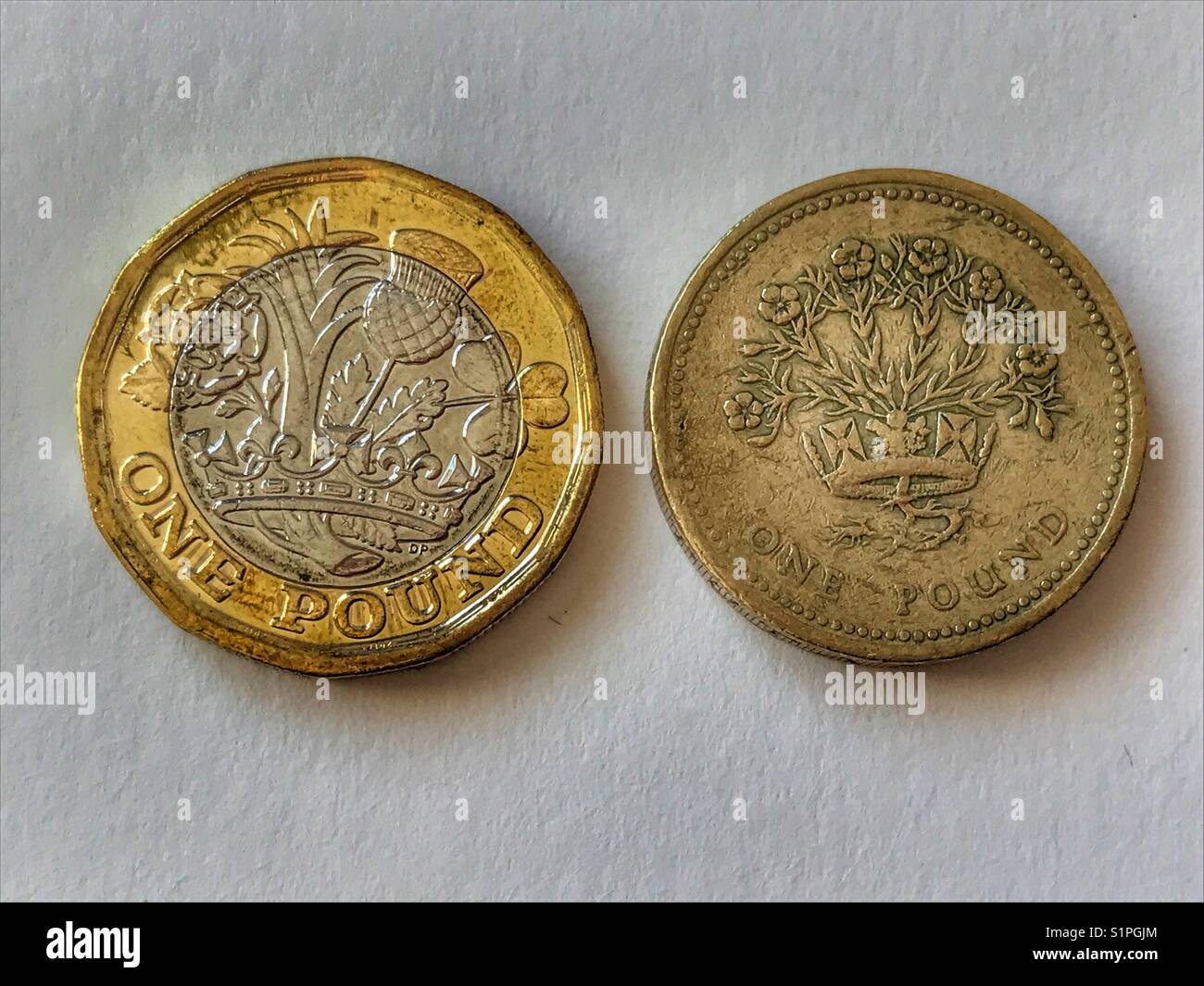 Currency, £ coins. Old and new. The old round coin is out of ...
