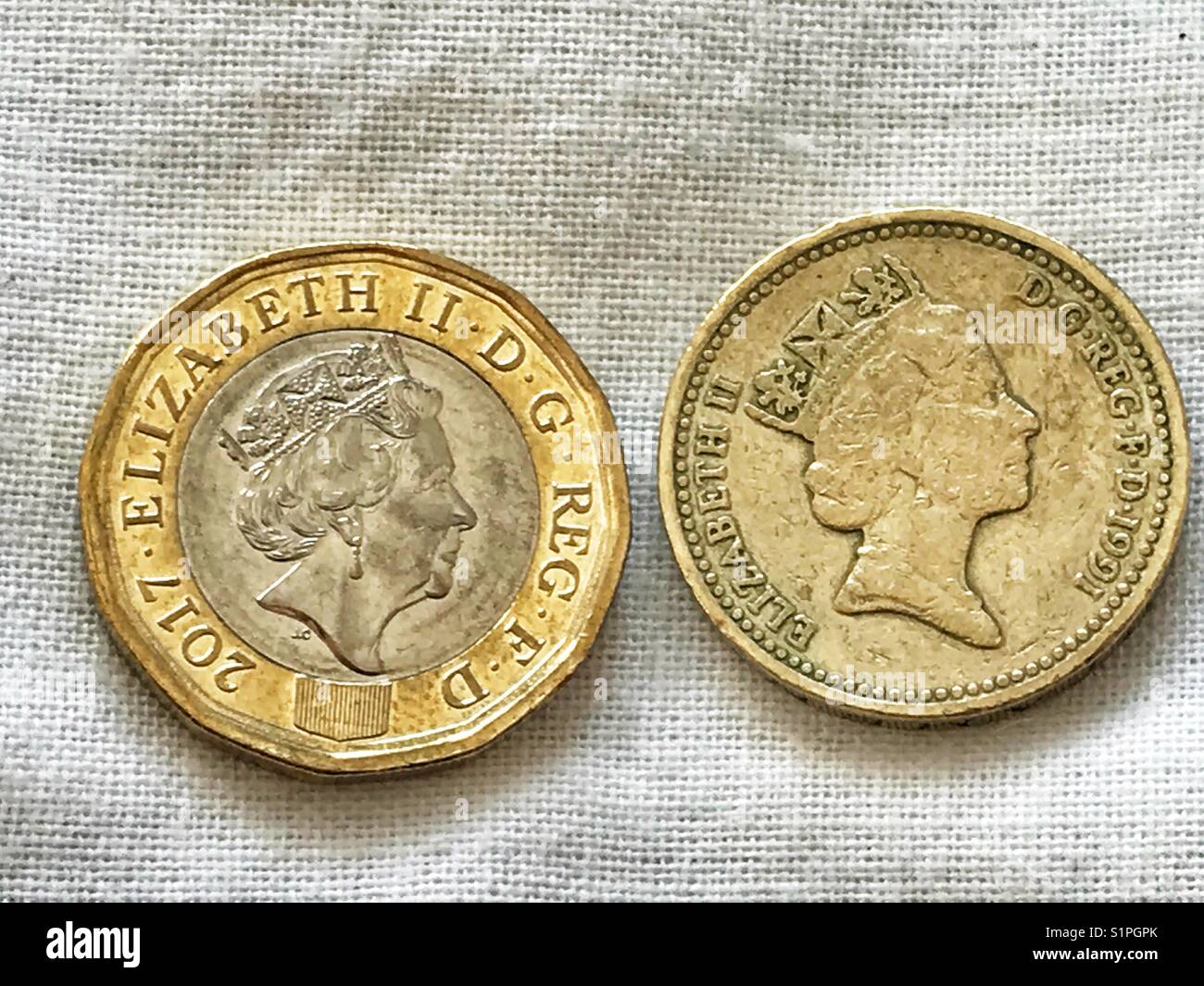 Currency, £ coins. Old and new. The old round coin is out of ...