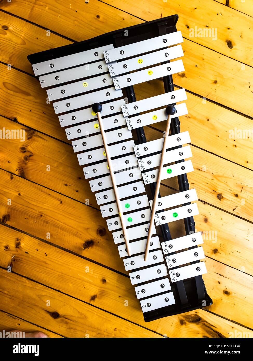 Xylophone with stickers and mallets on an old pine wood floor Stock ...