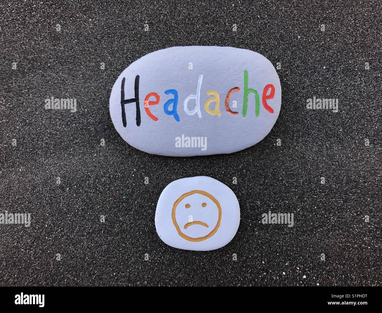 Headache text on a stone Stock Photo - Alamy