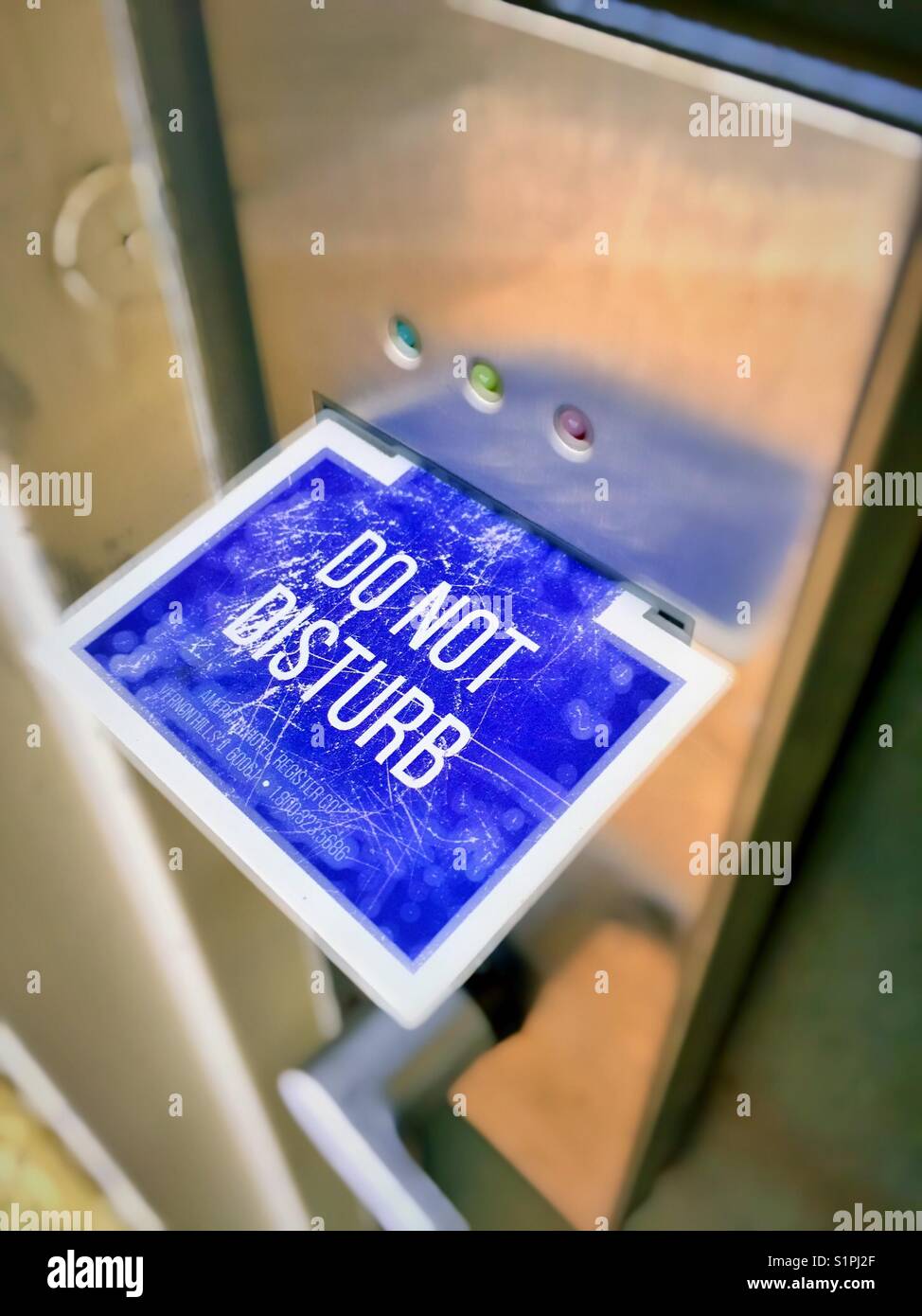 Hotel room door with do not disturb tab in key card slot on lock and ...