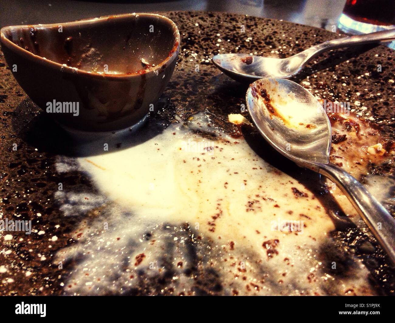 A dirty plate with spoons and bowl Stock Photo - Alamy
