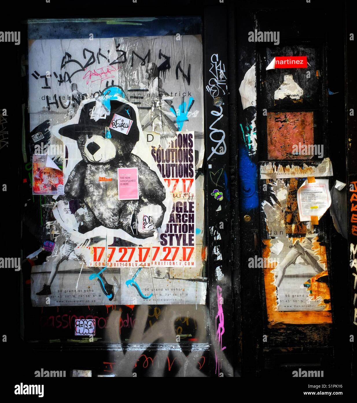 A wall covered with graffiti and advertisements Stock Photo - Alamy