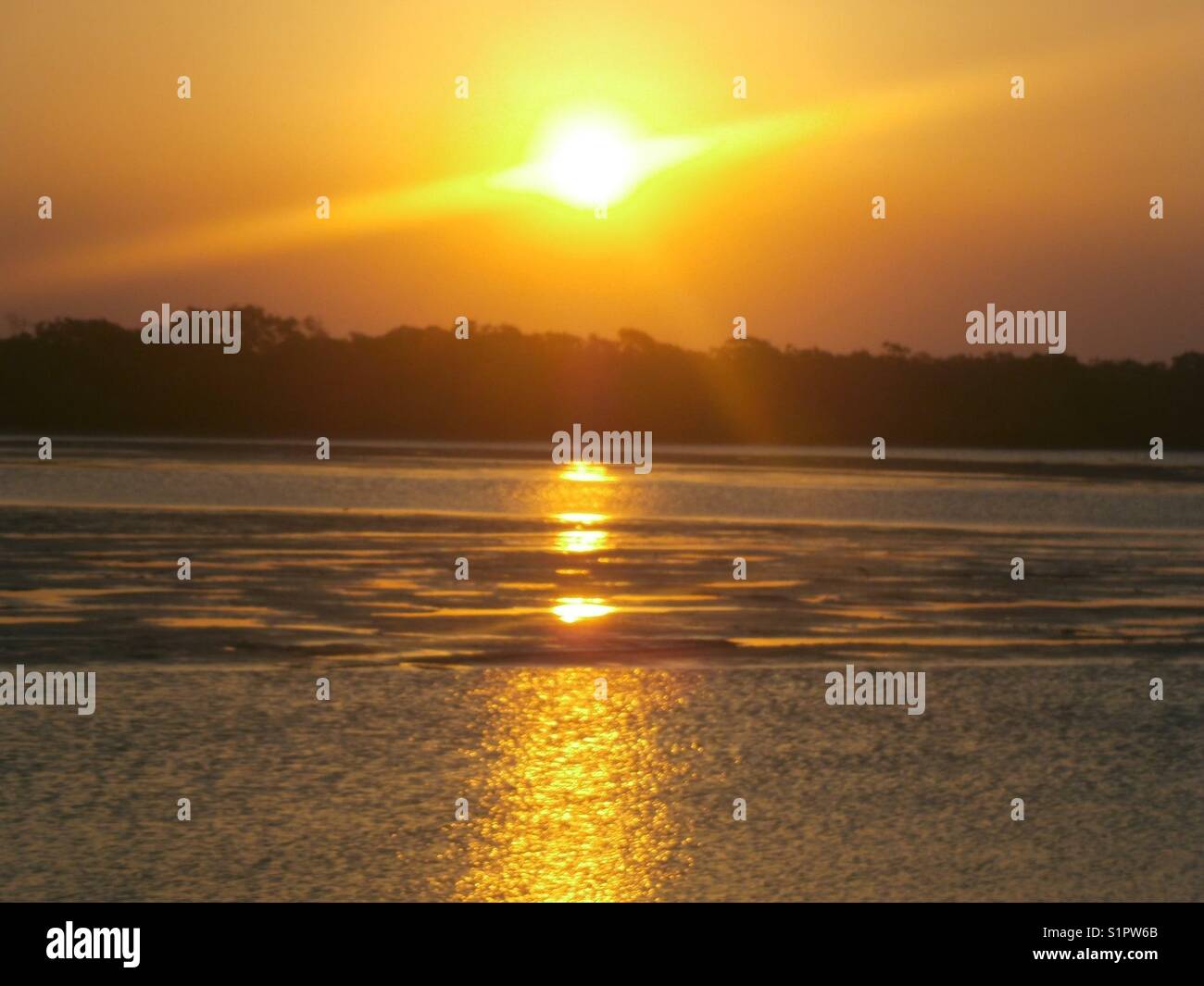 Shimmering sunset by the water Stock Photo - Alamy