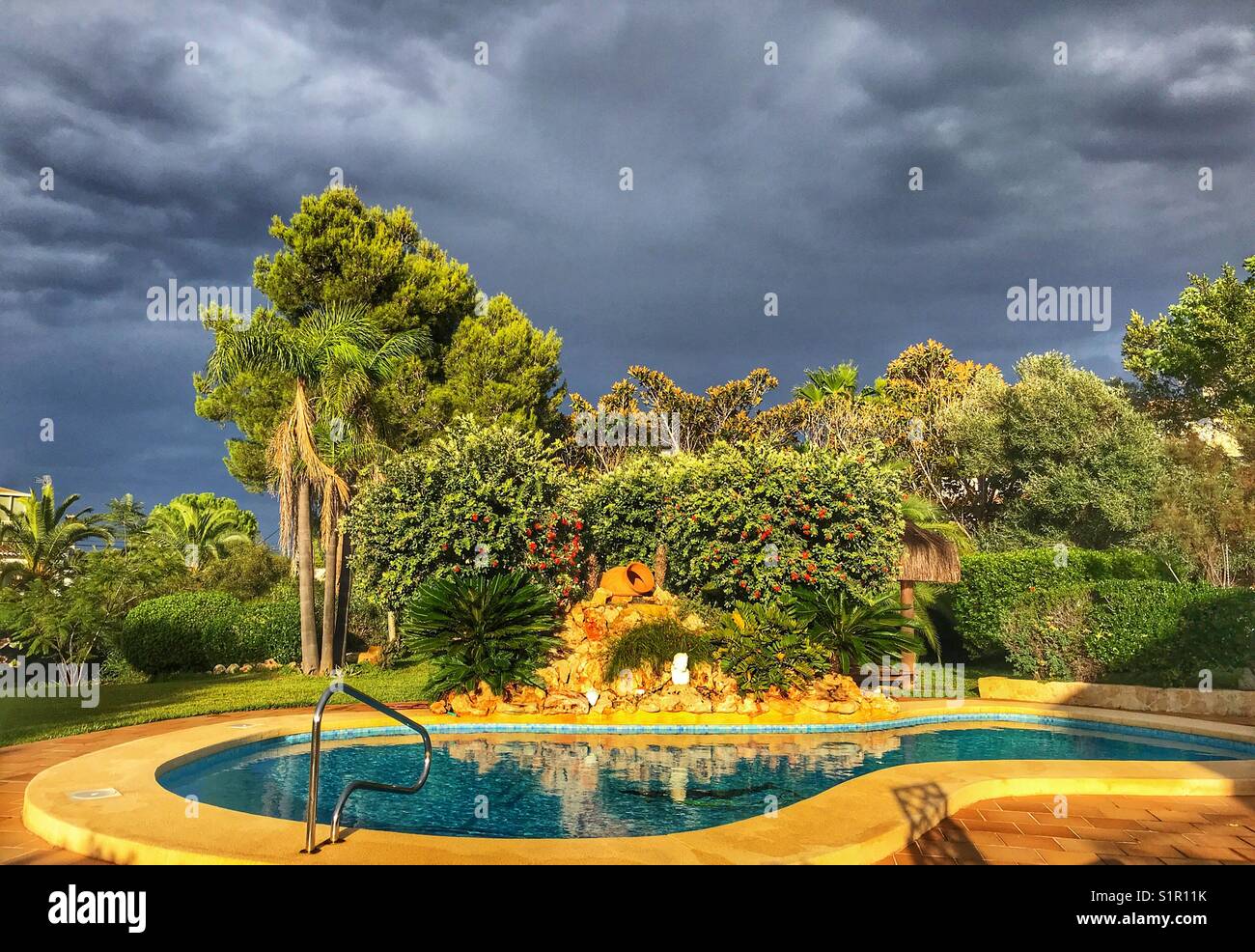 Spanish garden bathed in sunlight after a dramatic rain storm Stock ...