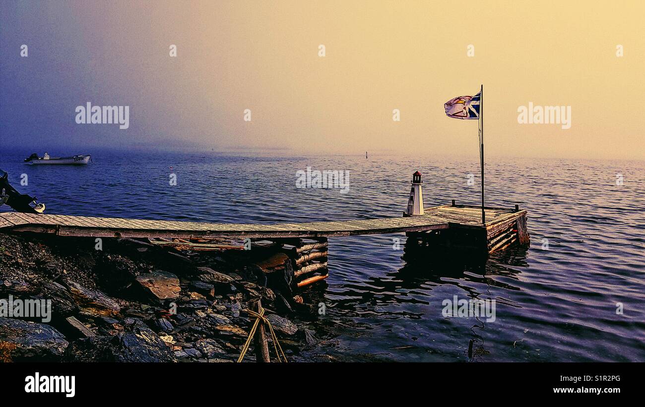 Rustic wooden jetty with model of a lighthouse and Newfoundland and ...
