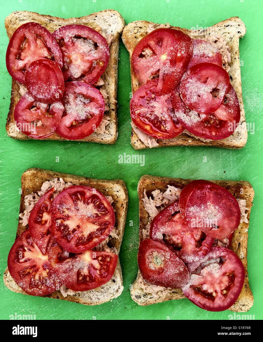 Four pieces of toast and tomato Stock Photo - Alamy