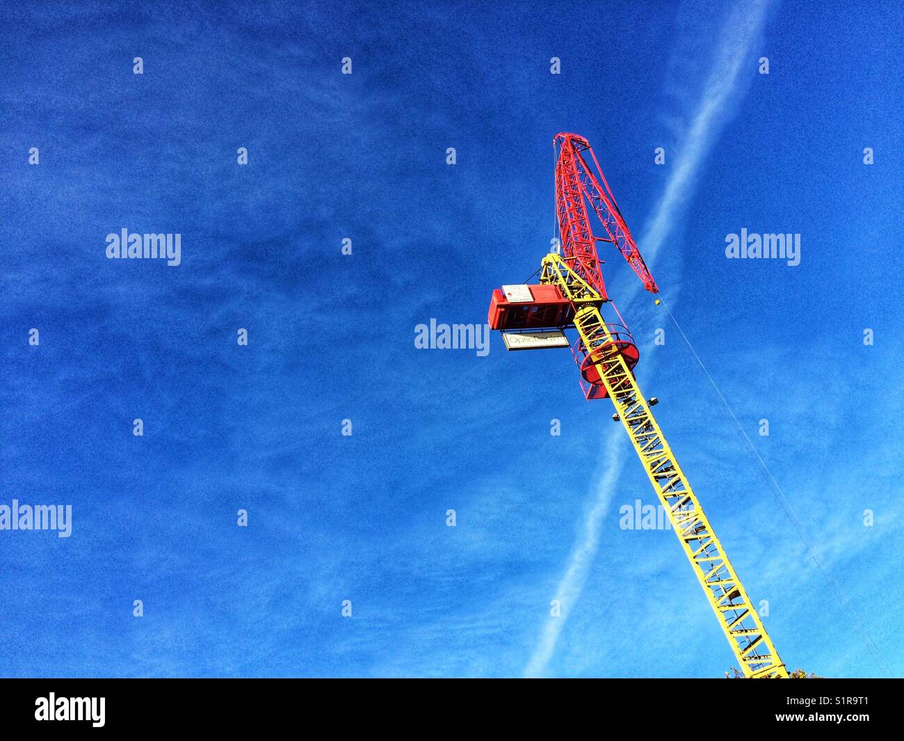 Static construction crane against deep blue sky Stock Photo - Alamy