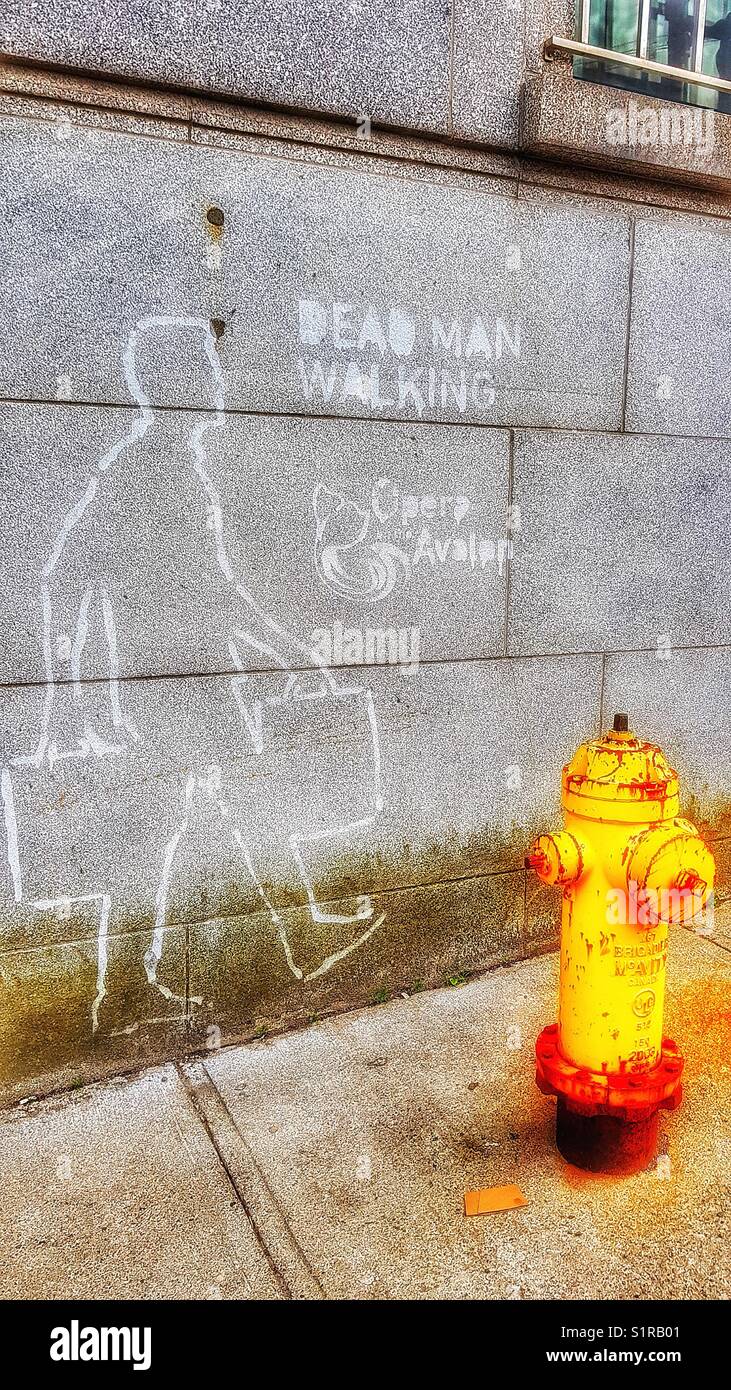 Yellow fire hydrant and urban graffiti of man carrying bags, St John’s ...