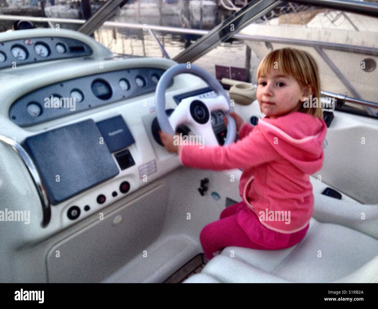 Kid girl driving boat hi-res stock photography and images - Alamy