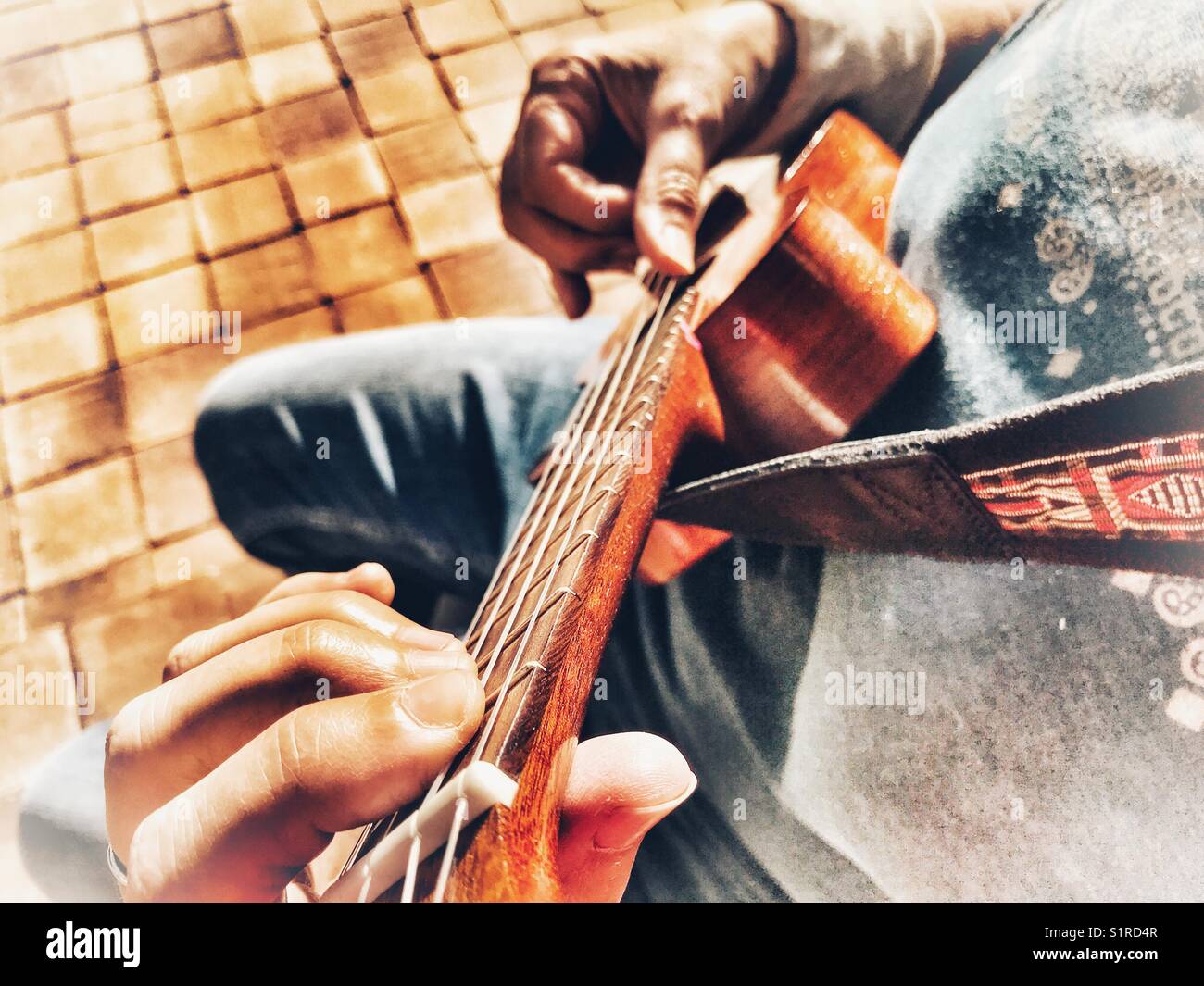 Woman playing a ukulele, high angle side view Stock Photo - Alamy