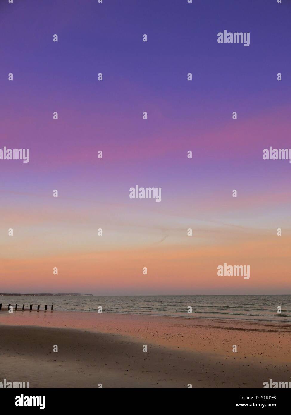 Colourful hues of sunset at the beach Stock Photo - Alamy