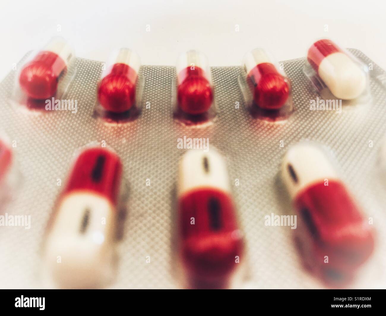 Red an white gel tablets in blister pack Stock Photo - Alamy