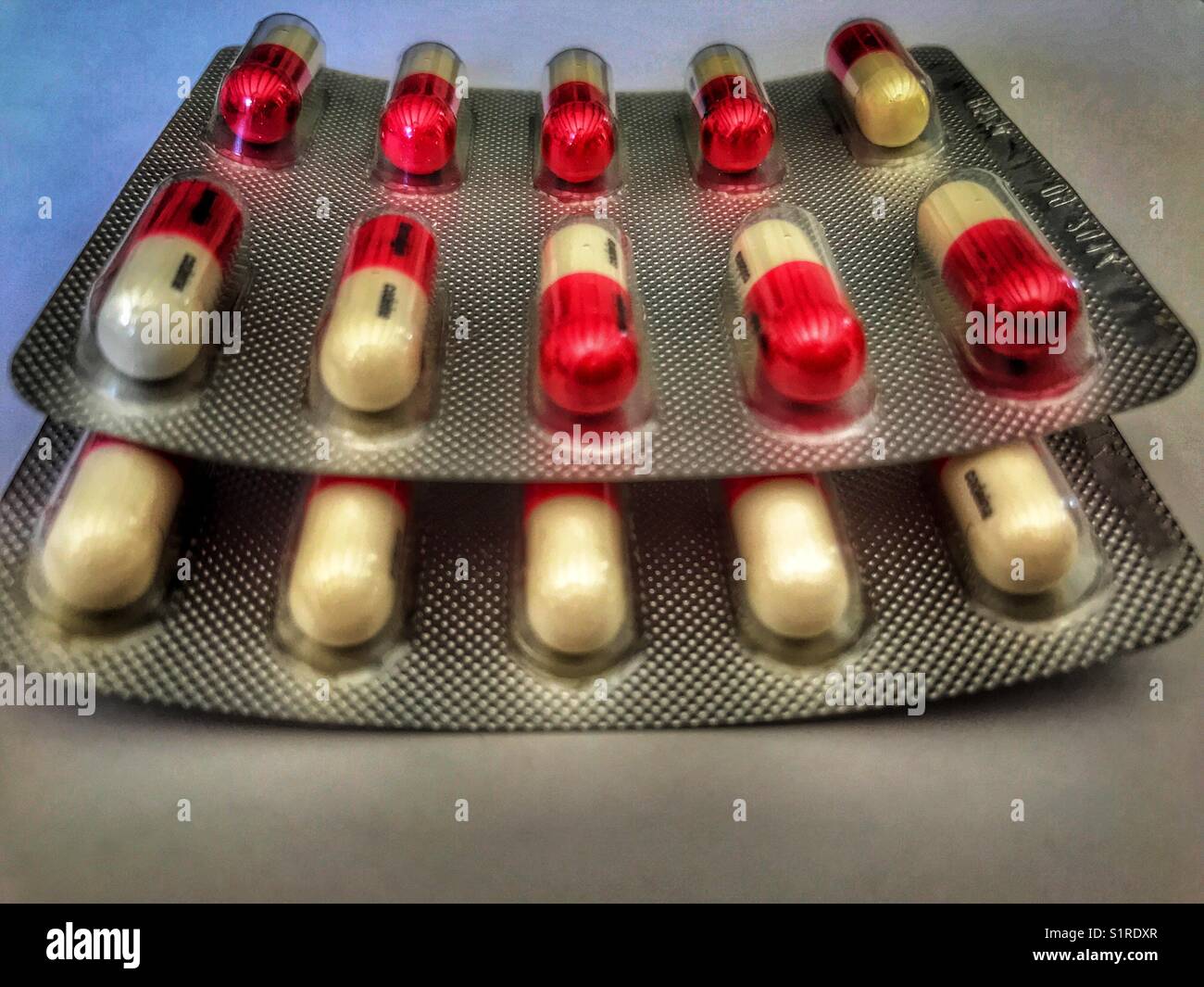 Red an white gel tablets in blister packs Stock Photo - Alamy