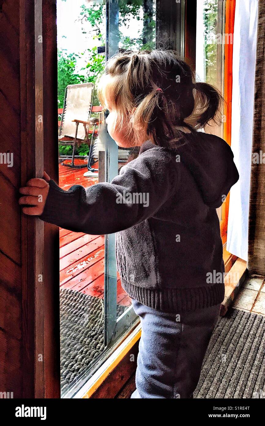 Girl in the window Stock Photo - Alamy