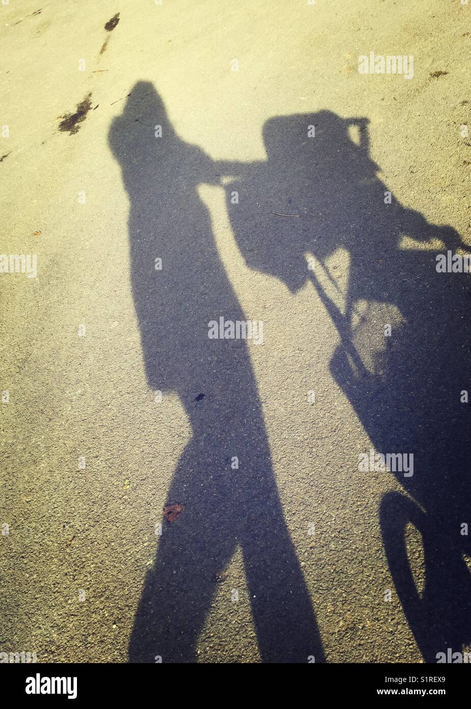 Shadow of a mother pushing her baby Stock Photo - Alamy