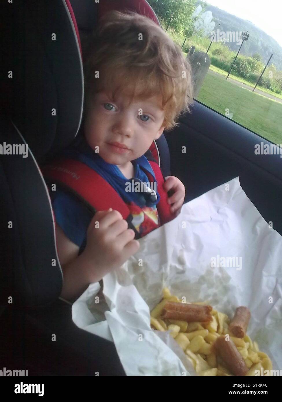 Child eating sausage and chips hi-res stock photography and images - Alamy