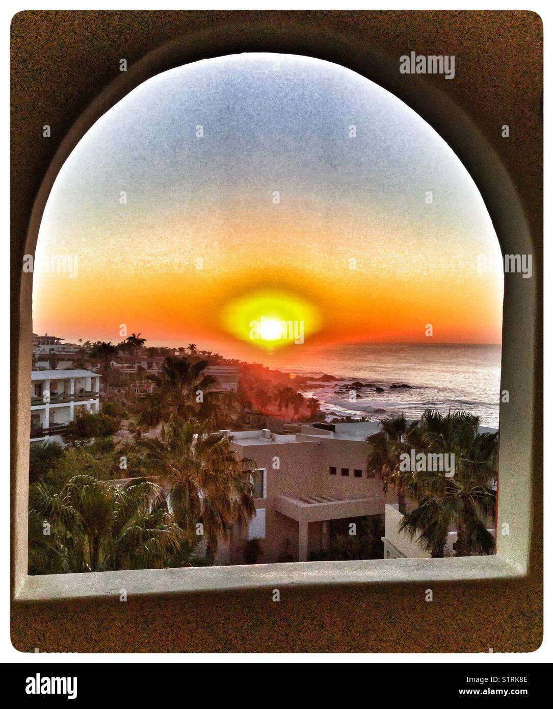 A sunrise seen from an open arched window Stock Photo - Alamy