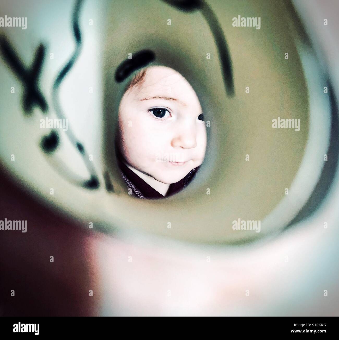 Looking through rolled up paper at toddler girl face Stock Photo - Alamy