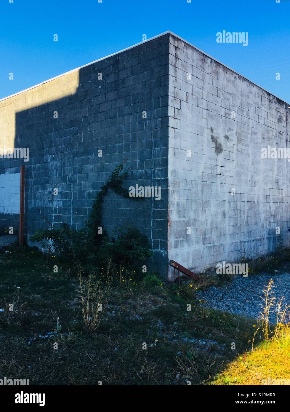 Block wall corner in shadow Stock Photo - Alamy