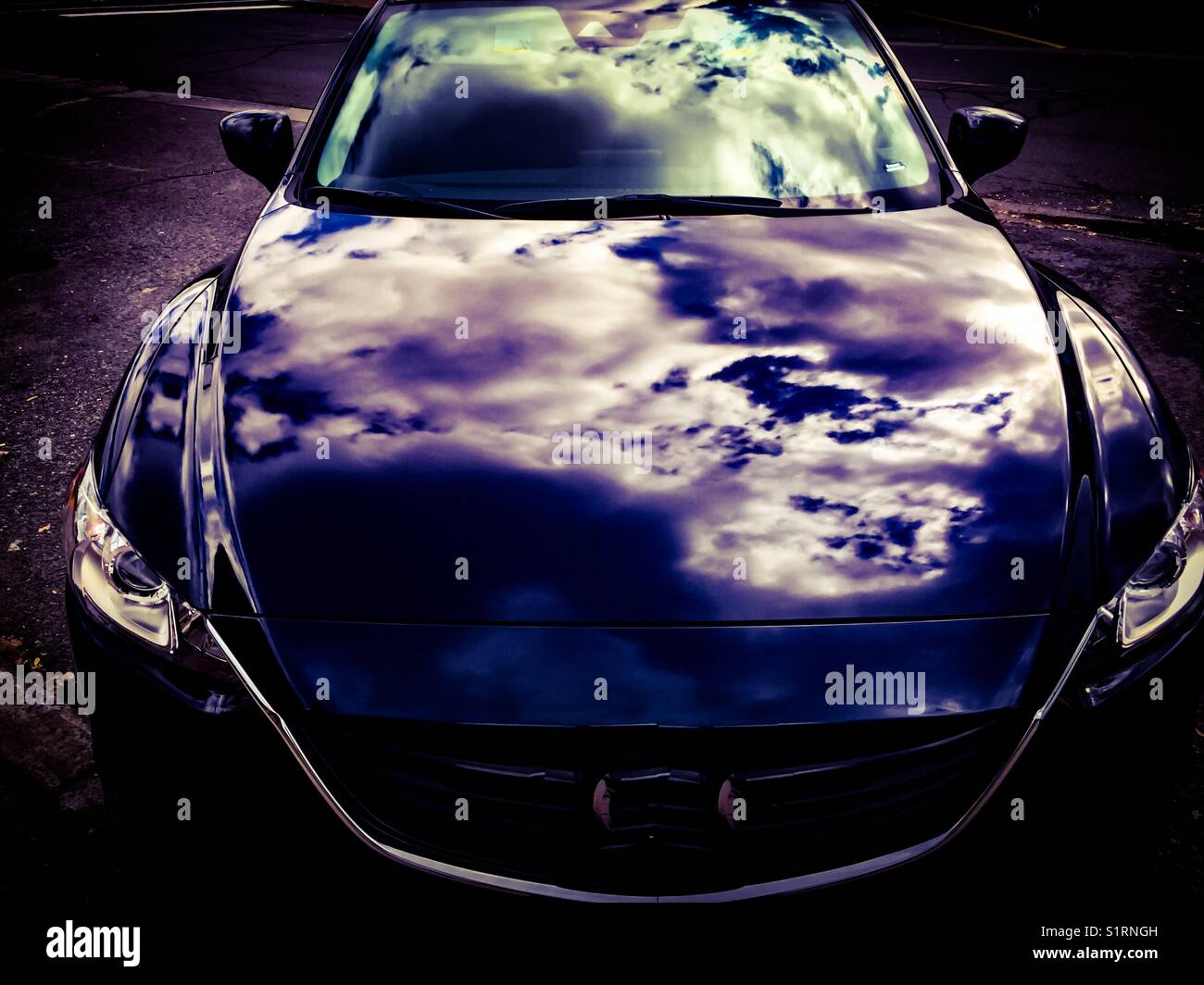 Clouds reflected on a parked car. Storm brewing. No people Stock Photo ...