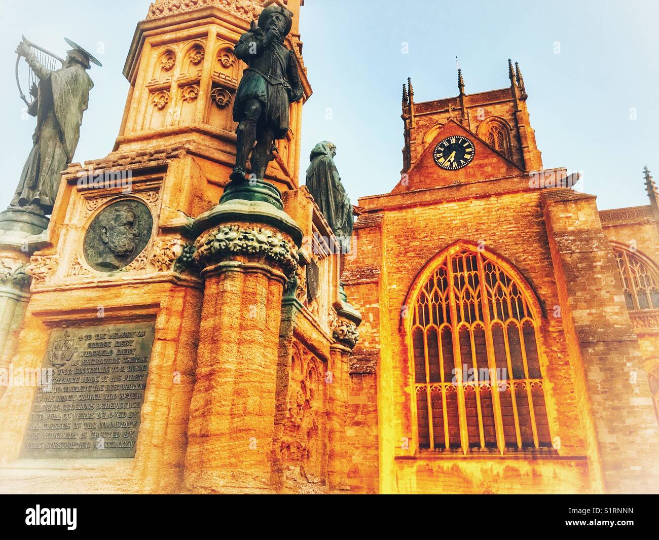Digby Memorial and Sherborne Abbey, historic building, floodlit at dawn ...
