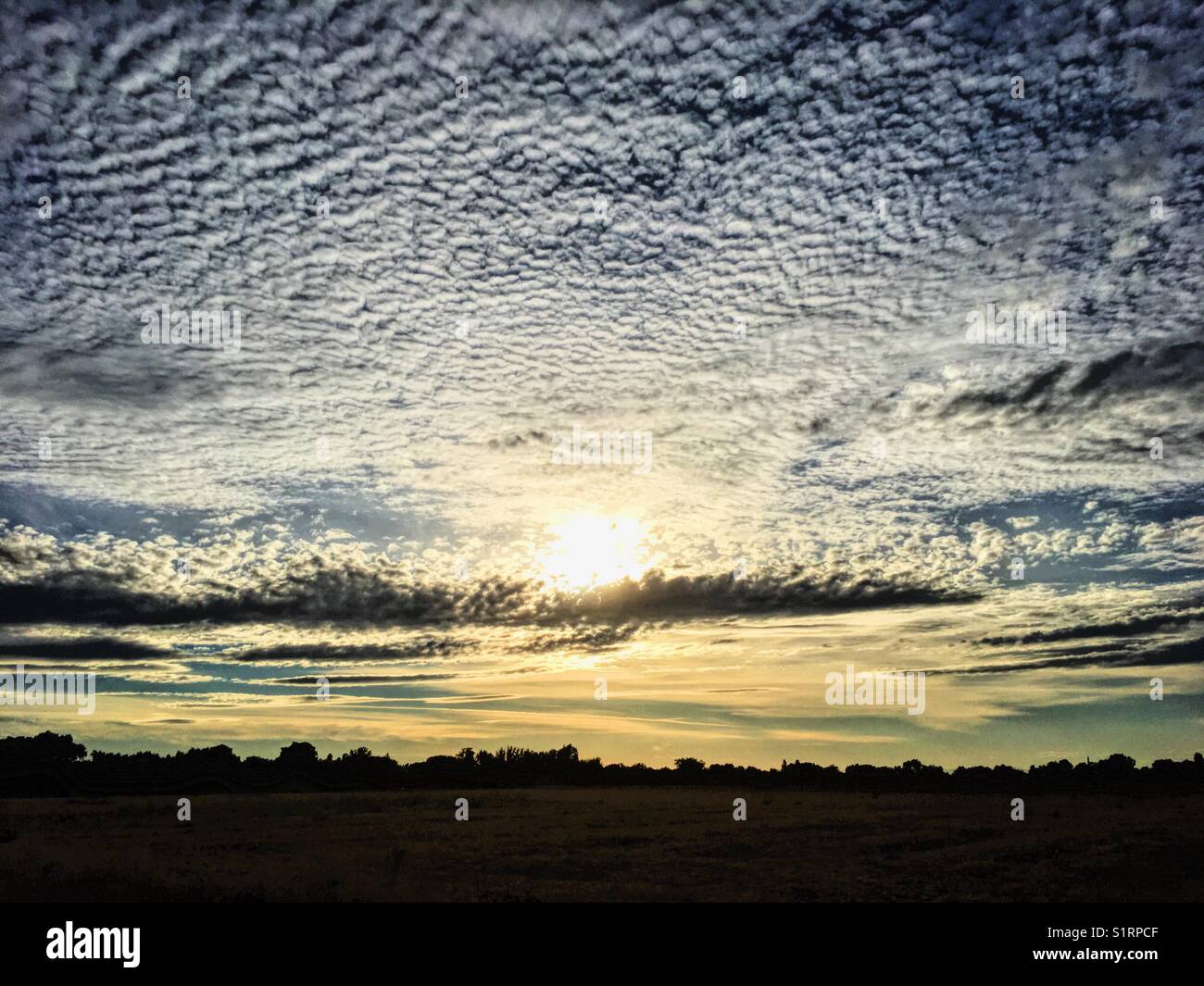 Sun shining through cloud patterns Stock Photo - Alamy