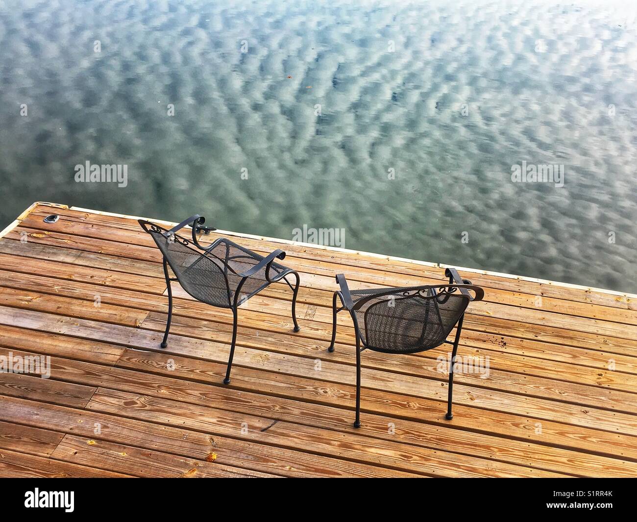 Two chairs on a floating dock Stock Photo - Alamy