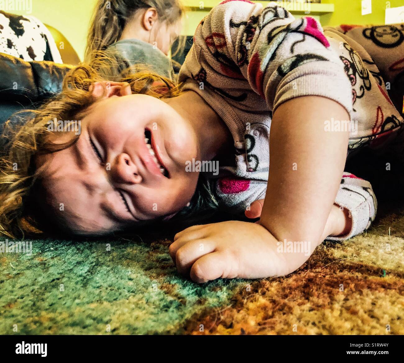 Toddler girl crying hard on carpeted floor Stock Photo - Alamy