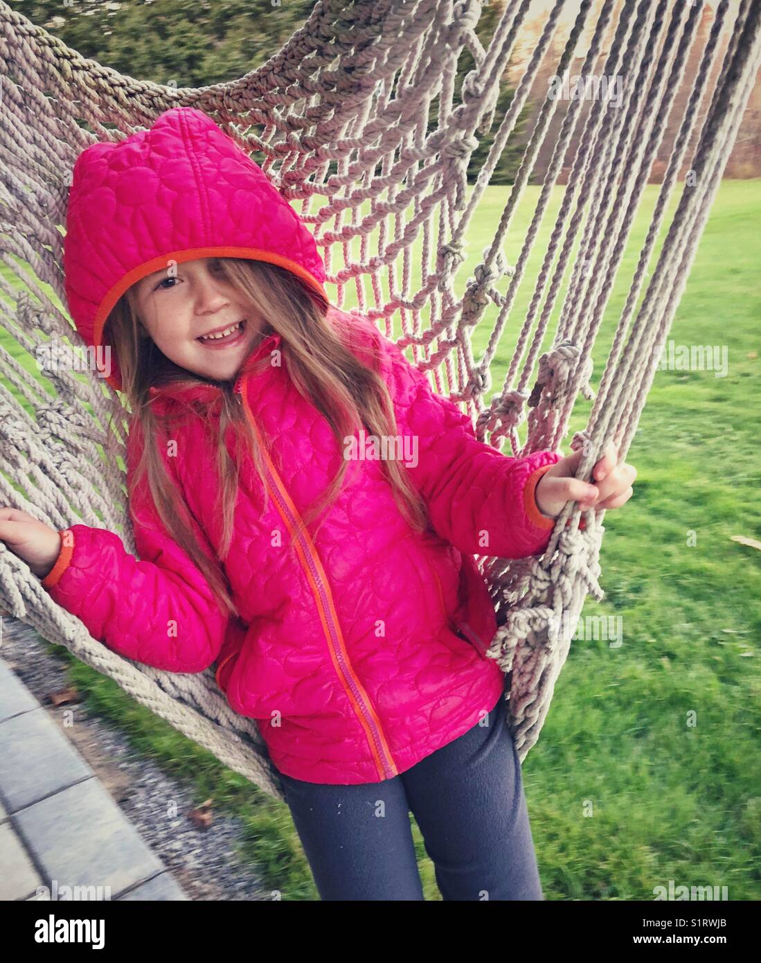Child swinging on chair hi-res stock photography and images - Alamy