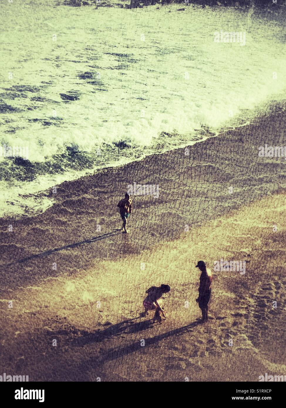 Three people having fun on the beach Stock Photo - Alamy