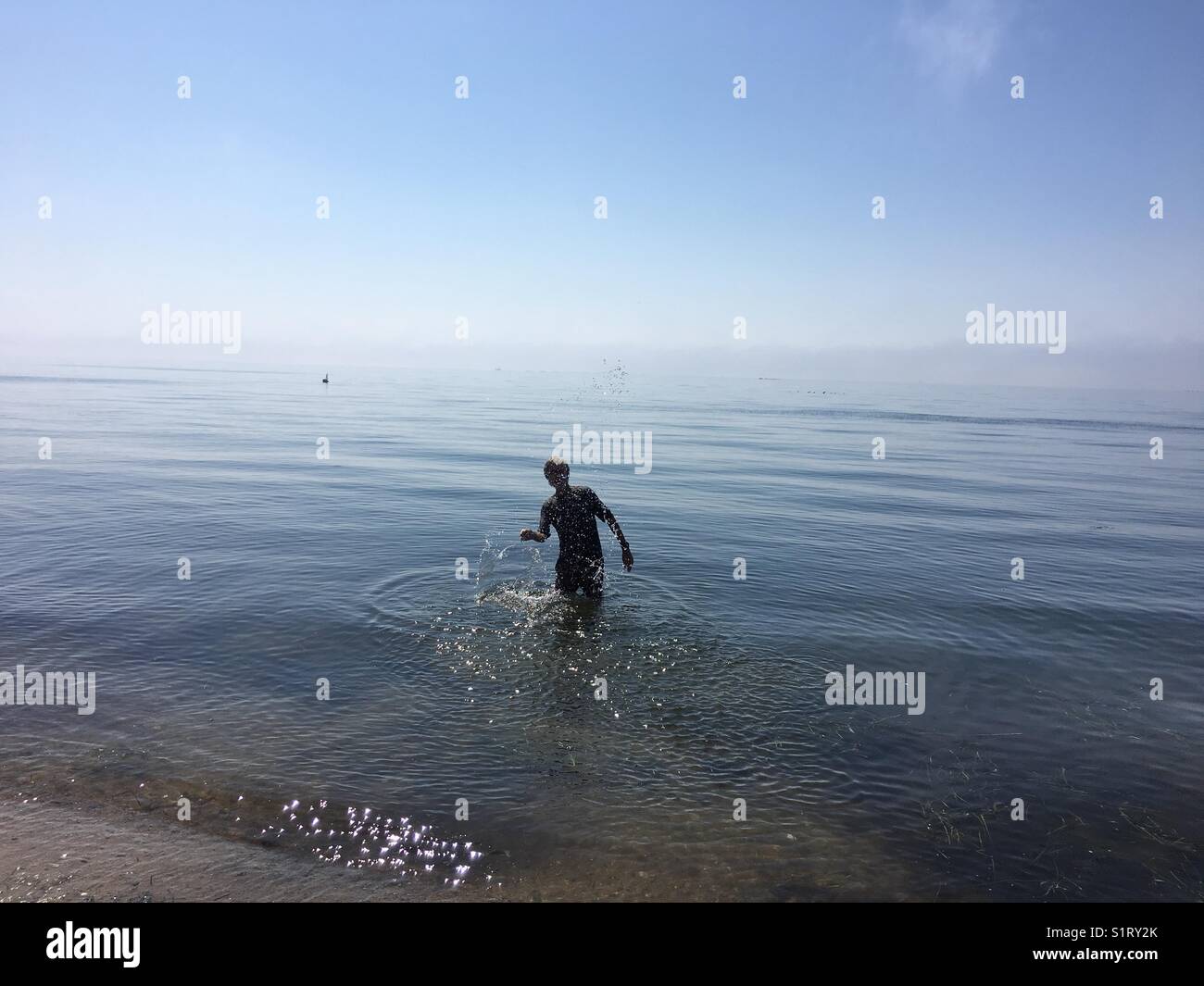 Man splashing in the ocean Stock Photo - Alamy