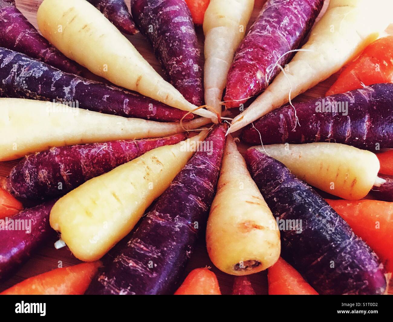 White, purple, orange, mini carrot Stock Photo - Alamy