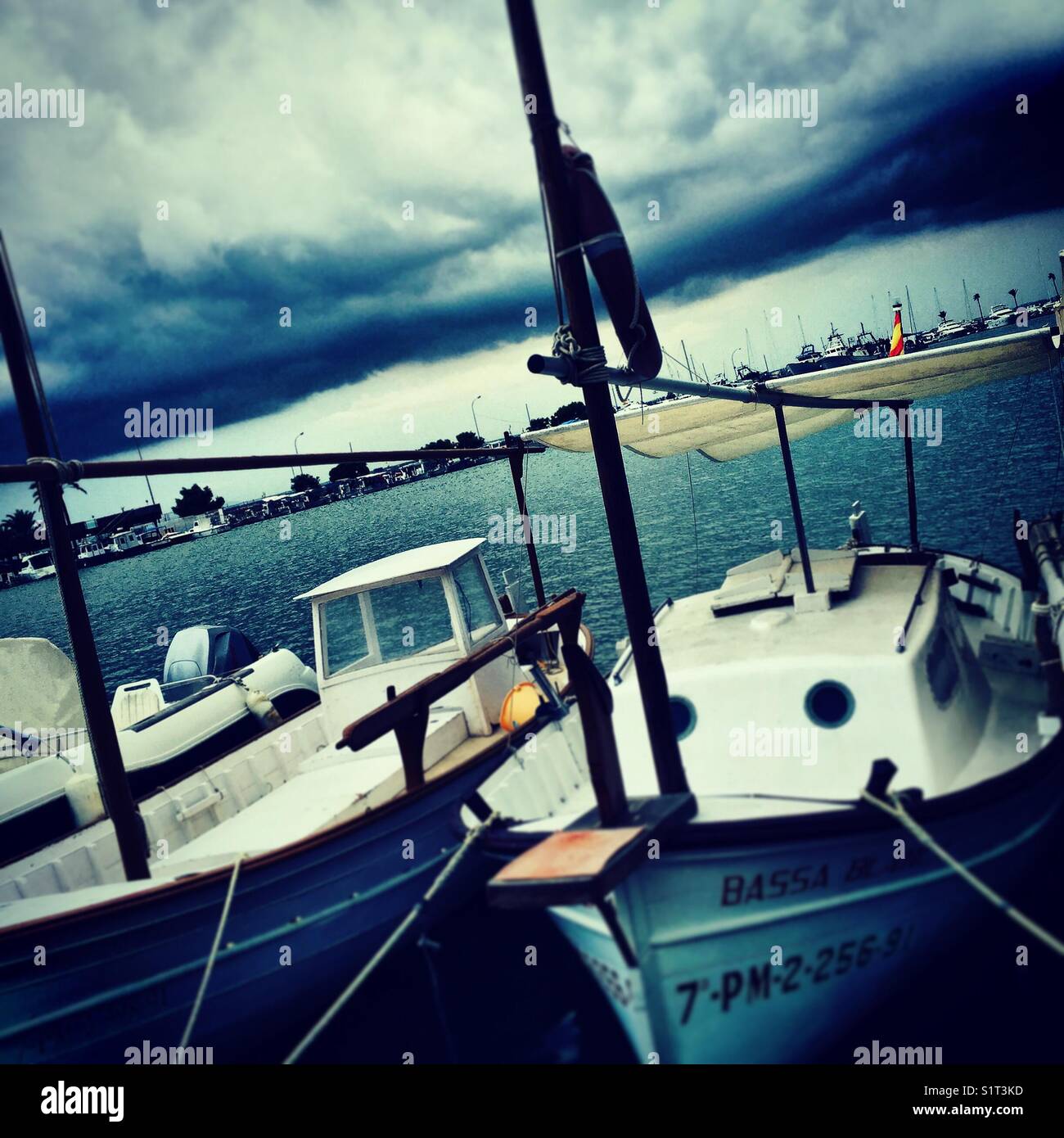 Boats in a coming storm Stock Photo - Alamy