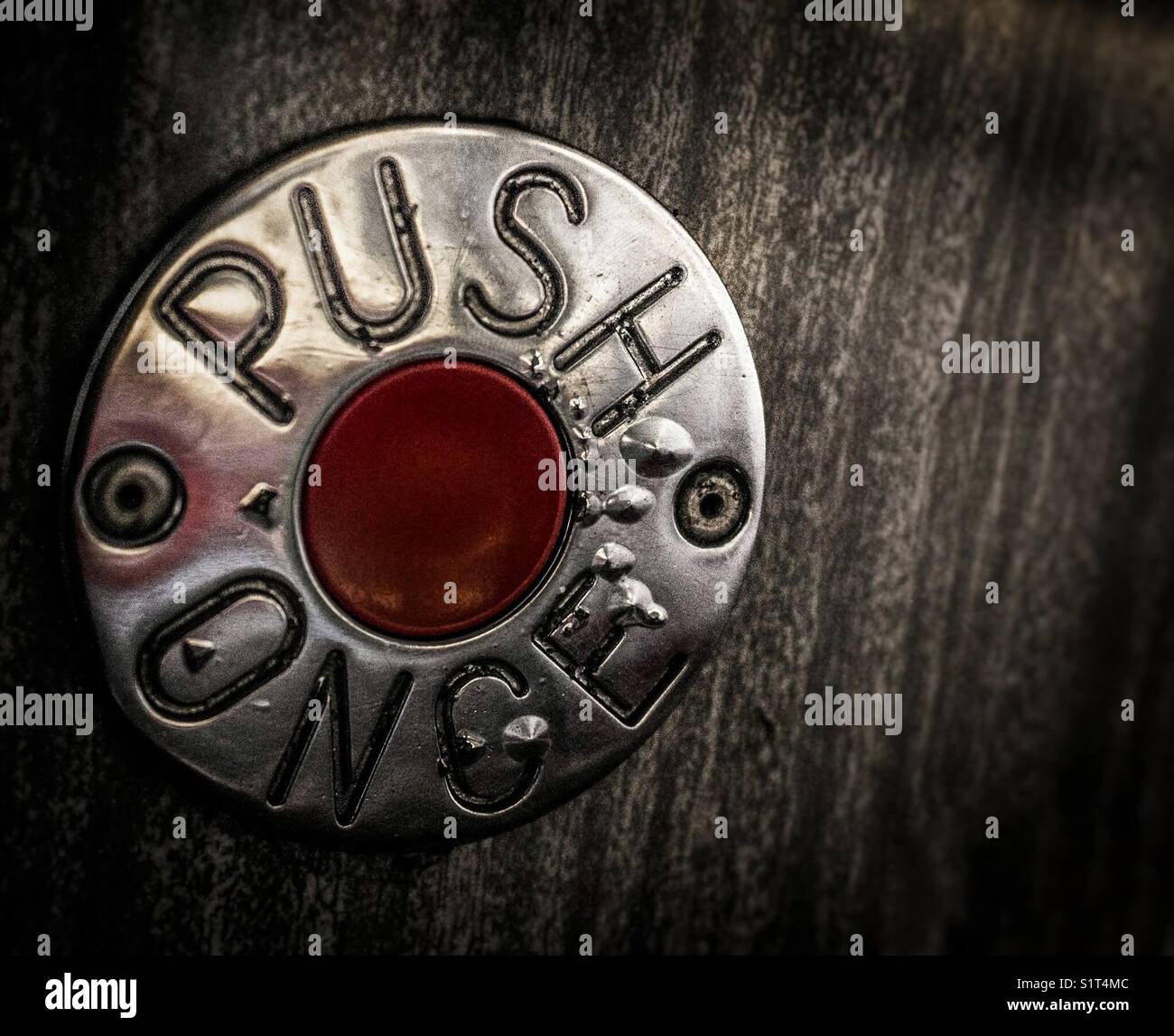 A red circular button that says push once Stock Photo - Alamy
