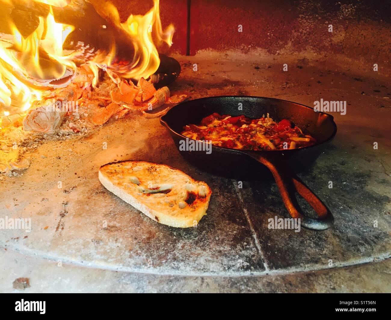 Wood fire cooking tomatoes and toast Stock Photo - Alamy