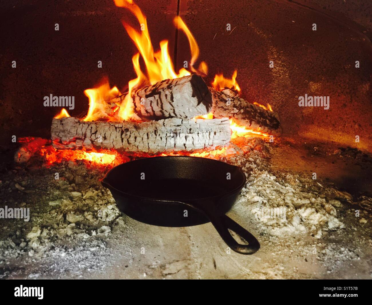 Wood fire oven warming cast iron pan Stock Photo - Alamy