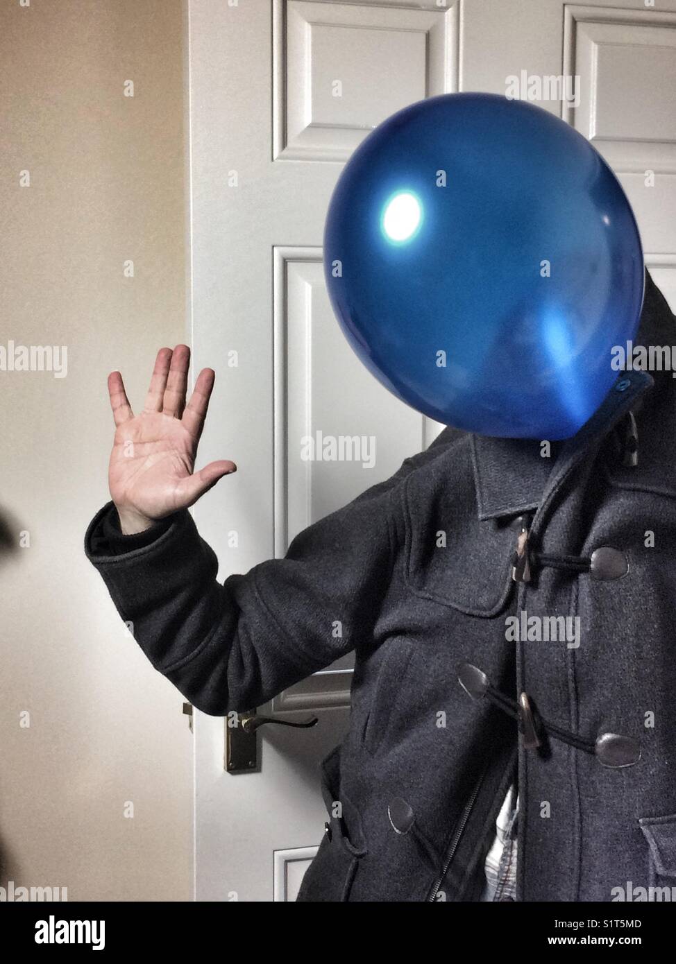 Blue balloon man waving Stock Photo - Alamy