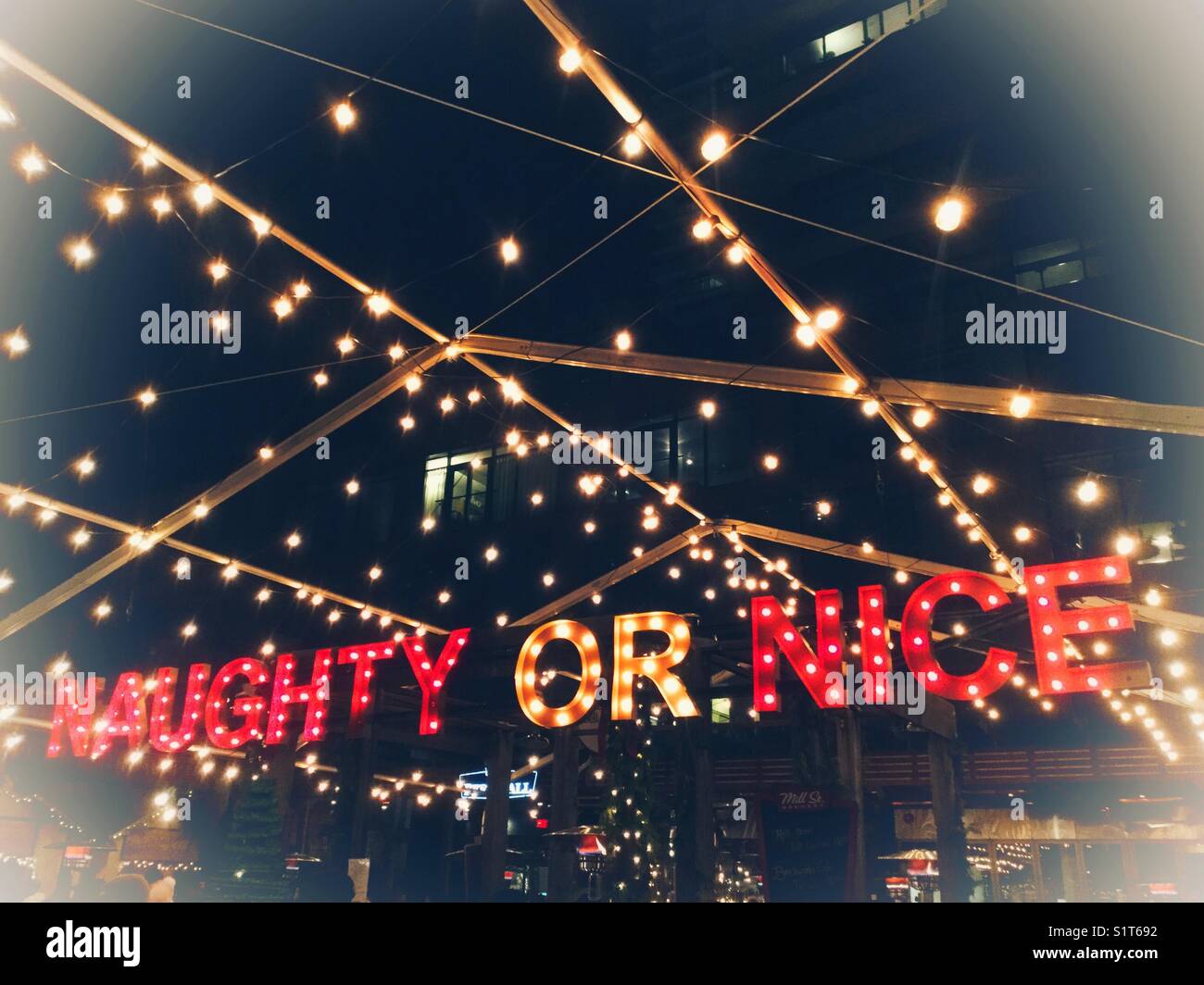 Naughty or nice in neon lights Stock Photo - Alamy