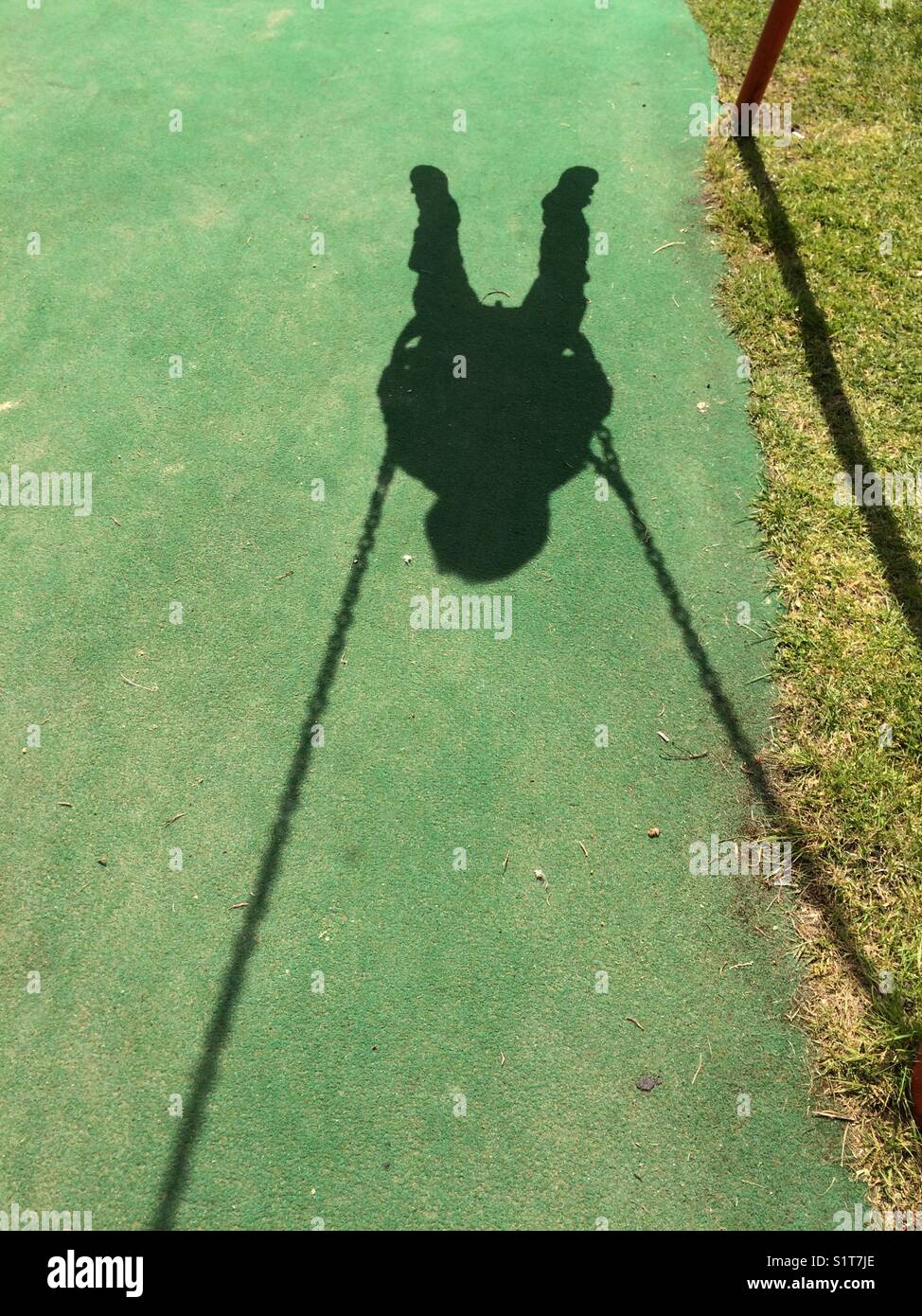 A shadow of a child on a swing Stock Photo - Alamy