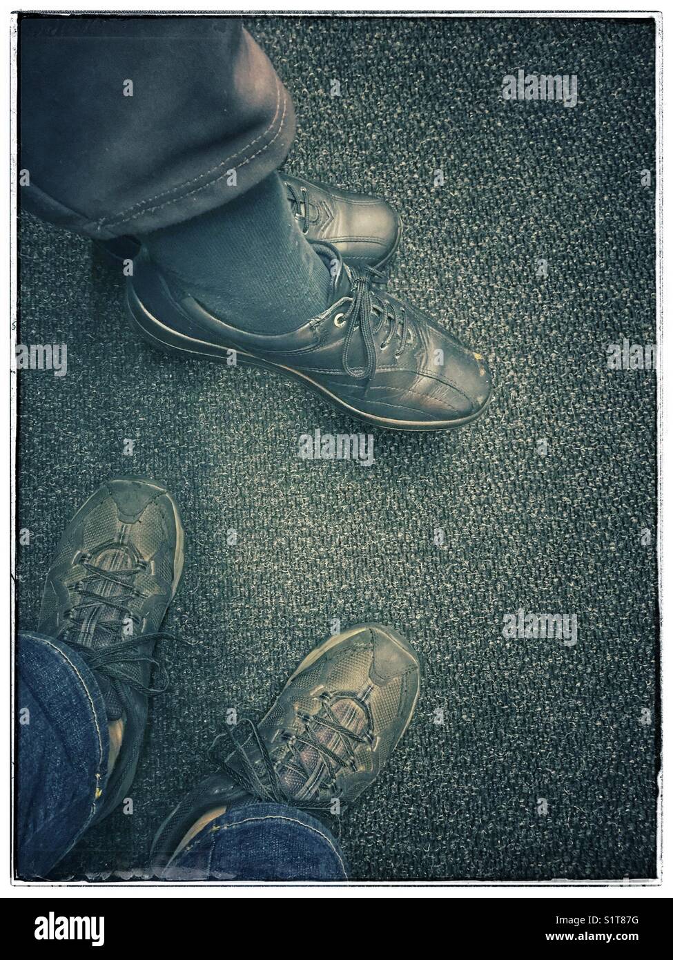 Feet of seated people seen from above Stock Photo - Alamy