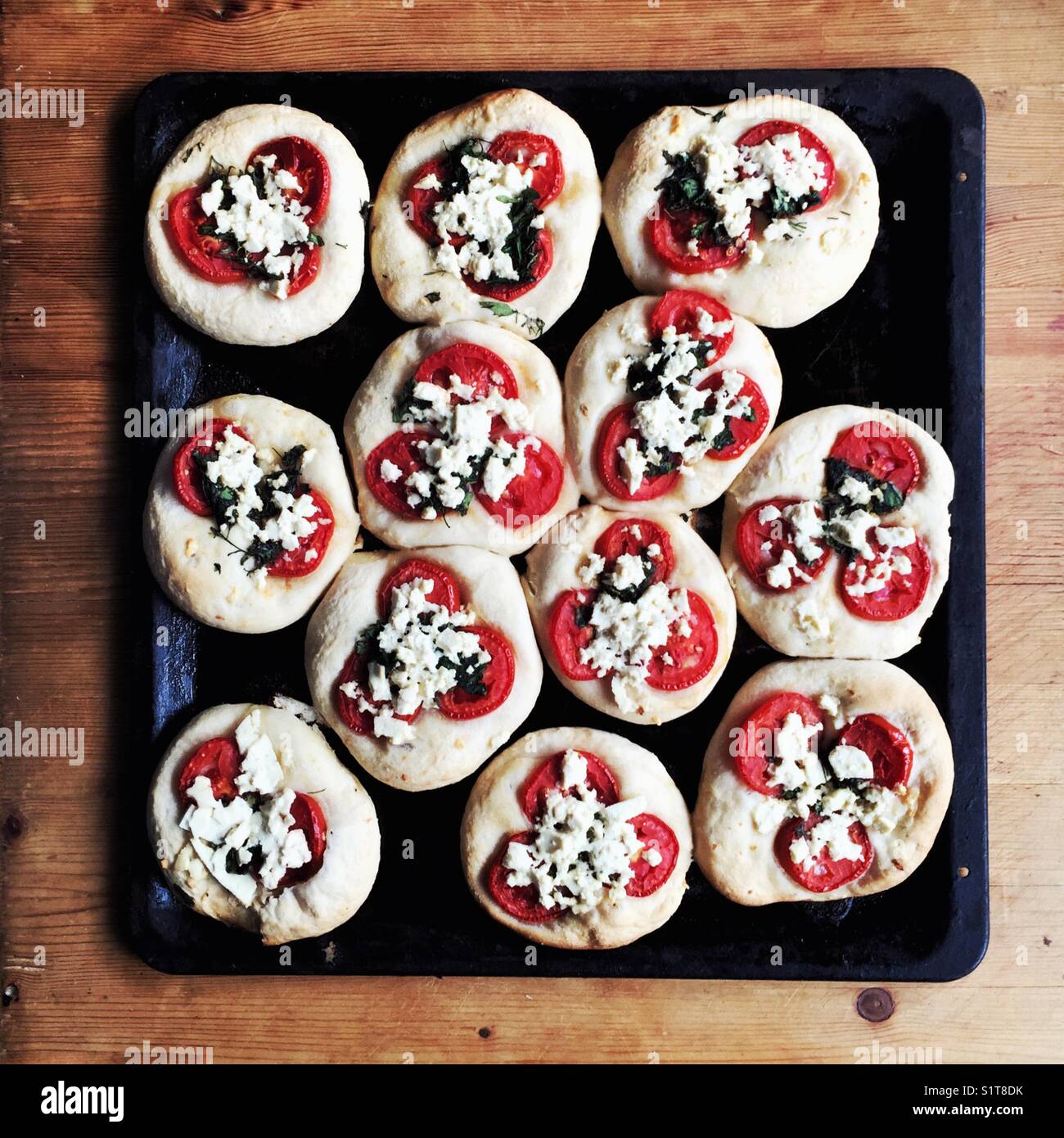 made from scratch mini pizza pies on the baking tray top view Stock ...