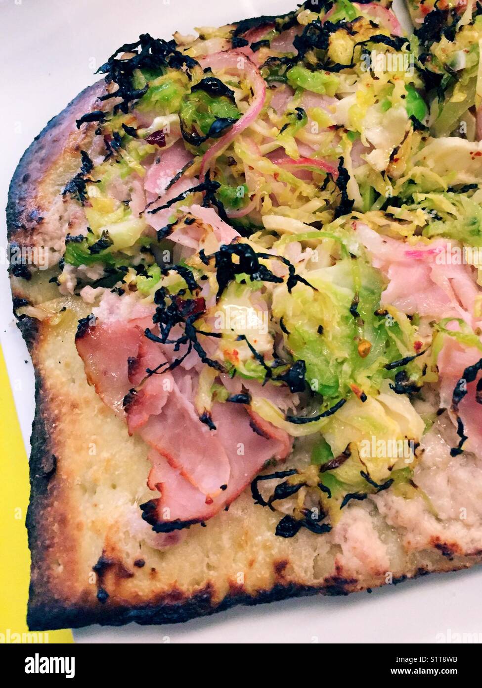 Flat bread pizza with shaved brussels sprouts and prosciutto toppings ...
