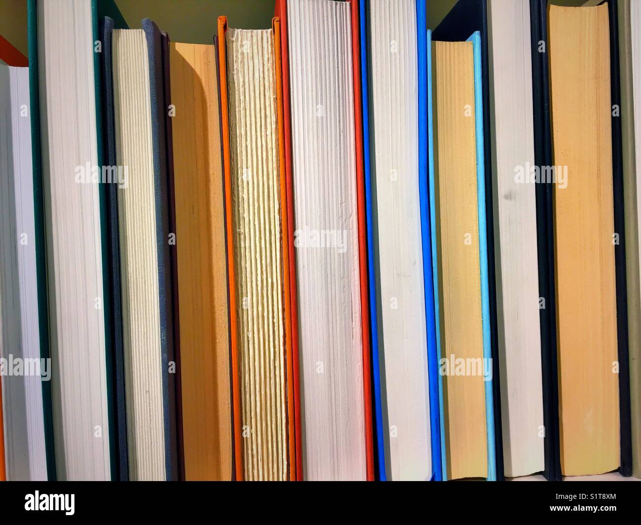 Generic hardback books on a bookshelf Stock Photo - Alamy